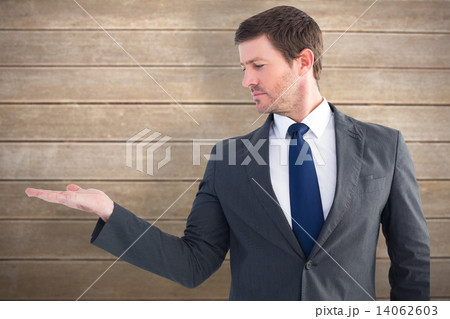 Composite image of businessman with his hand outの写真素材 [14062603] - PIXTA