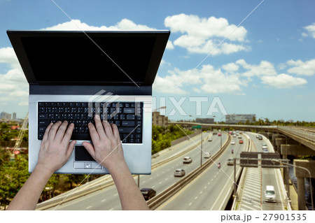 Woman using laptop with blurry expressway の写真素材 [27901535] - PIXTA