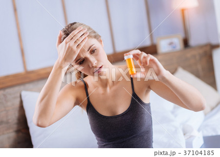 Young woman touching her forehead and holdingの写真素材 [37104185] - PIXTA