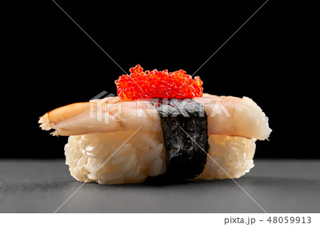Ebi nigiri topped with red flying fish roe.の写真素材 [48059913] - PIXTA