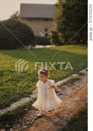 Beautiful little baby girl running in a whiteの写真素材 [57070320] - PIXTA
