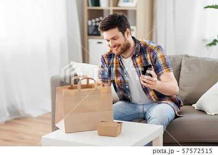 man checking takeaway food order at home 57572515 PIXTA