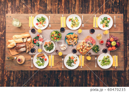 Table setting with silver cutlery, ceramic plates and delicious food ...