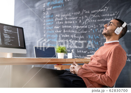 Young relaxed office manager or programmer...の写真素材 [62830700] - PIXTA