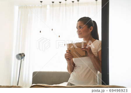 Low-spirited lady with a framed photograph...の写真素材 [69496923] - PIXTA