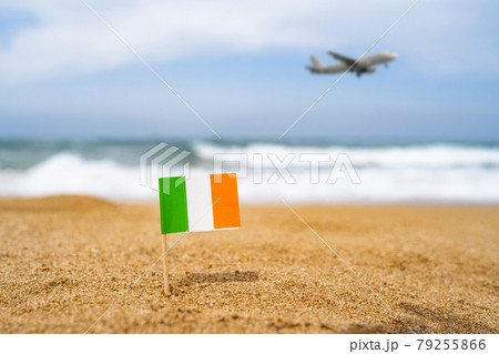 Flag of Ireland in the form of a toothpick in the sand of beach ...