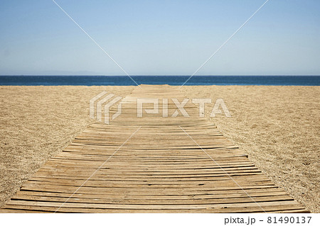 Wooden plank path on sand on the beach on a...の写真素材 [81490137] - PIXTA