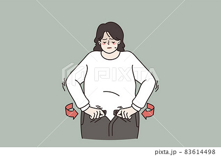 Overweight woman unable to fasten jeans belt 83614498 PIXTA