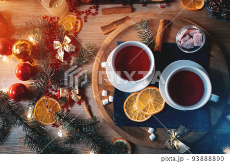 two cups of black or berry red christmas tea, decorated candle, top ...