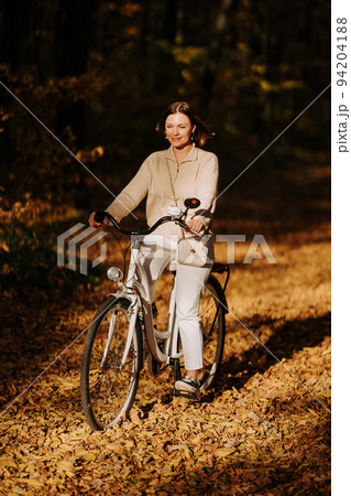 Young pretty woman riding vintage white bicycle...の写真素材 [94204188] - PIXTA
