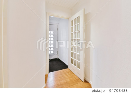 Narrow corridor with white walls and doors...の写真素材 [94708483] - PIXTA