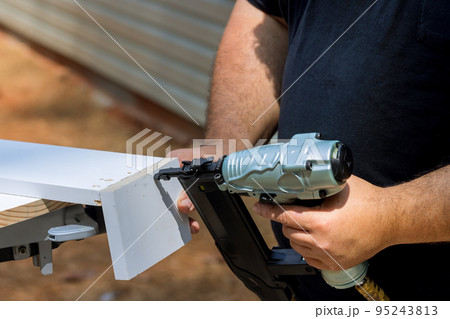 With help of pneumatic air gun carpenter...の写真素材 [95243813] - PIXTA