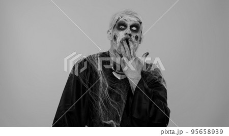 Scary excited man Halloween zombie raising...の写真素材 [95658939] - PIXTA