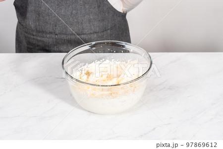 Mixing ingredients in a glass mixing bowl to...の写真素材 [97869612] - PIXTA