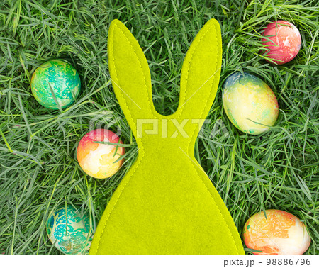 Green felt rabbit with colored eggs. Easter....の写真素材 [98886796] - PIXTA