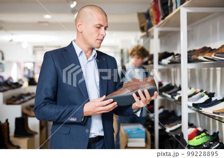 Handsome man chooses classic brown shoes in...の写真素材 [99228895] - PIXTA
