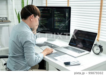 Male programmer is programming to develop...の写真素材 [99879302] - PIXTA
