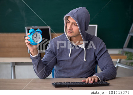 Young male hacker sitting in the classroomの写真素材 [101518375] - PIXTA
