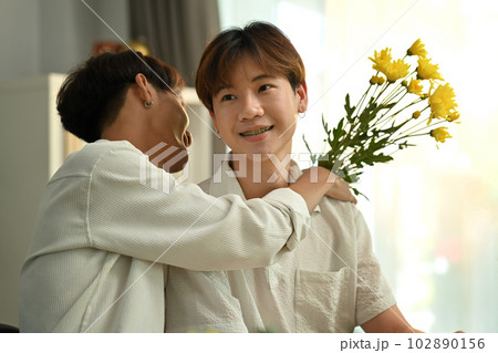 Shot of romantic asian man giving a bunch of...の写真素材 [102890156] - PIXTA