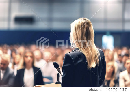 Rear view of a long-haired blond woman speaking...のイラスト素材 [103704157 ...