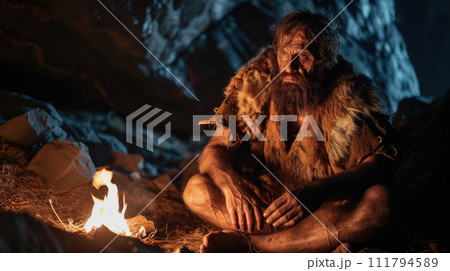 Caveman sits near fire in cave at night,...のイラスト素材 [111794589] - PIXTA