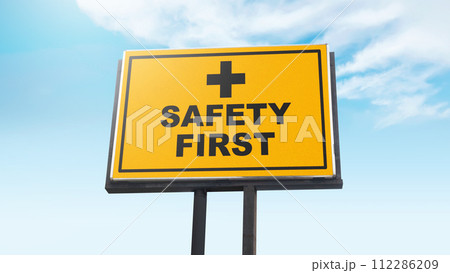 Safety first with yellow sign on blue sky background as a warning ...