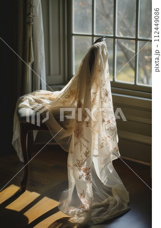 Elegant fabric draped over chair in sunlight by...のイラスト素材 [112449086 ...