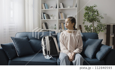 Teen girl returning home from school, taking...の写真素材 [112840593] - PIXTA