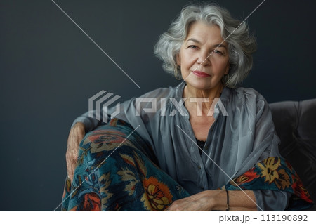 A woman is sitting on a couch with a floral...のイラスト素材 [113190892] - PIXTA