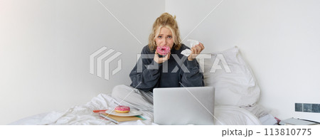 Portrait of sad woman crying, eating doughnut,...の写真素材 [113810775] - PIXTA