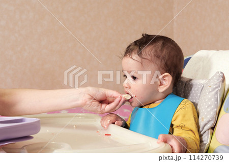 Portrait of little baby boy eating food. Baby...の写真素材 [114270739] - PIXTA