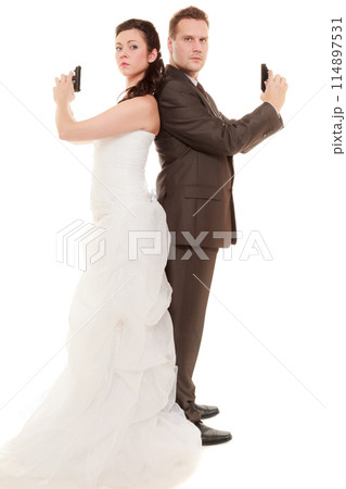 Wedding couple. Bride groom with handgun weaponの写真素材 [114897531] - PIXTA