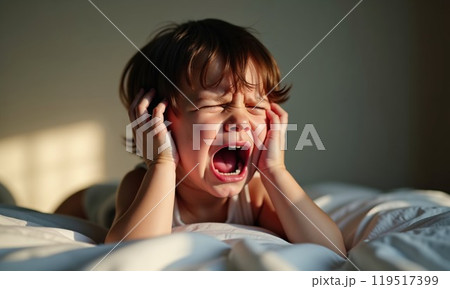 A small boy is crying quietly while lying atop...のイラスト素材 [119517399 ...