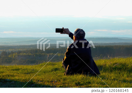 A man is capturing a selfie in a picturesque...の写真素材 [120168145] - PIXTA