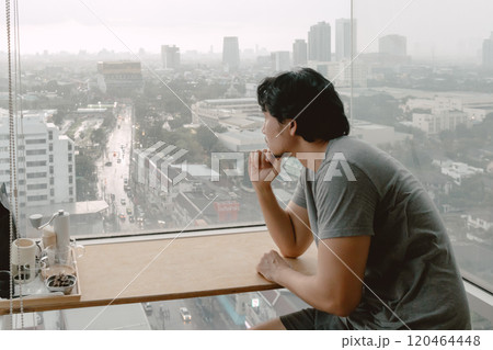 Lonely single man looking out to through the...の写真素材 [120464448] - PIXTA