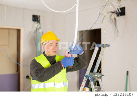 Electrician working with wires in apartmentの写真素材 [122219107] - PIXTA