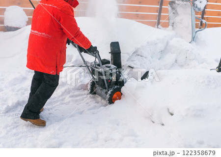 Closeup of red snow blower in action. Senior...の写真素材 [122358679] - PIXTA