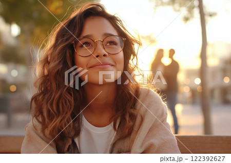 Hispanic girl enjoying a warm sunset while...のイラスト素材 [122392627] - PIXTA