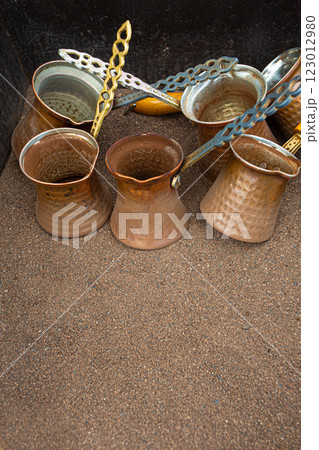 Traditional copper coffee pots on coarse sandの写真素材 [123012980] - PIXTA