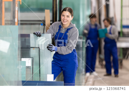 Young woman stacking glass sheets in factoryの写真素材 [123368741] - PIXTA