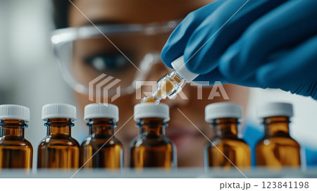 Scientist carefully dropping liquid in vial...のイラスト素材 [123841198] - PIXTA