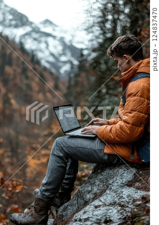 Man during hike sitting on a rock with a laptop...のイラスト素材 [124837470 ...