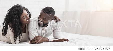 Romantic african american couple cuddling on...の写真素材 [125173897] - PIXTA
