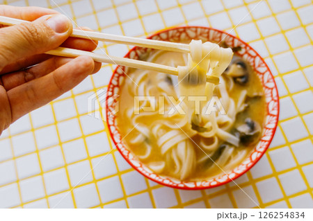 person is eating noodles with chopsticks....の写真素材 [126254834] - PIXTA