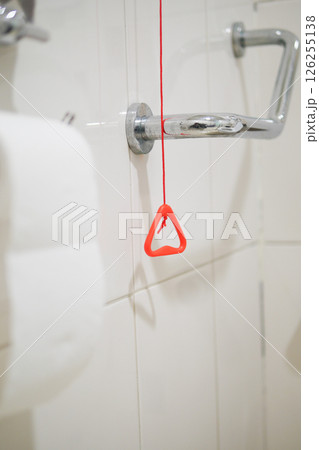 Red triangle pull cord hanging in a bathroom...の写真素材 [126255138] - PIXTA