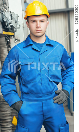 Young engineer wearing blue overall and yellow...のイラスト素材 [126330309 ...