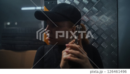 Close Up of Female Secret Agent Hiding Behind...の写真素材 [126461496] - PIXTA