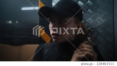 Close Up of Female Secret Agent Hiding Behind...の写真素材 [126461511] - PIXTA