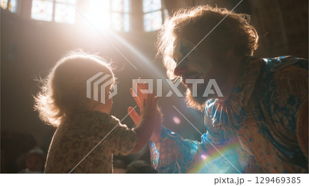 Clown engaging joyfully with a young child in a...のイラスト素材 [129469385 ...