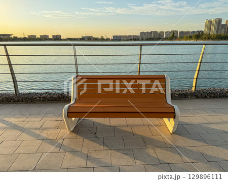 Modern bench on waterfront promenade at sunsetの写真素材 [129896111] - PIXTA